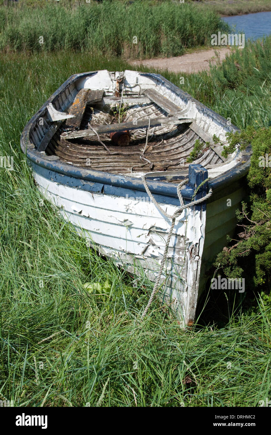 An old boat left to rot on the shore at Brancaster Stock Photo - Alamy