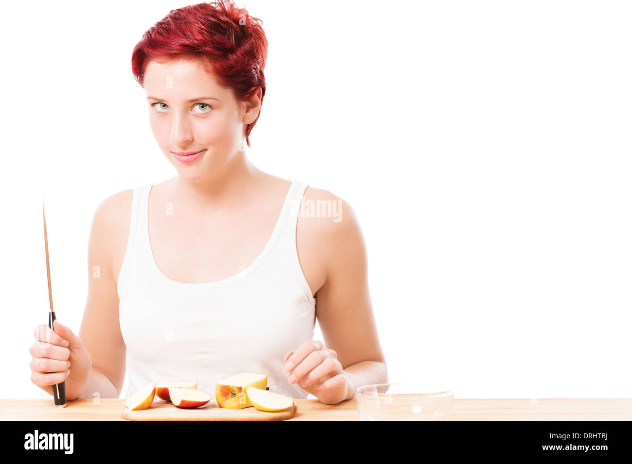 diabolic looking woman with a knife and a sliced apple on white ...