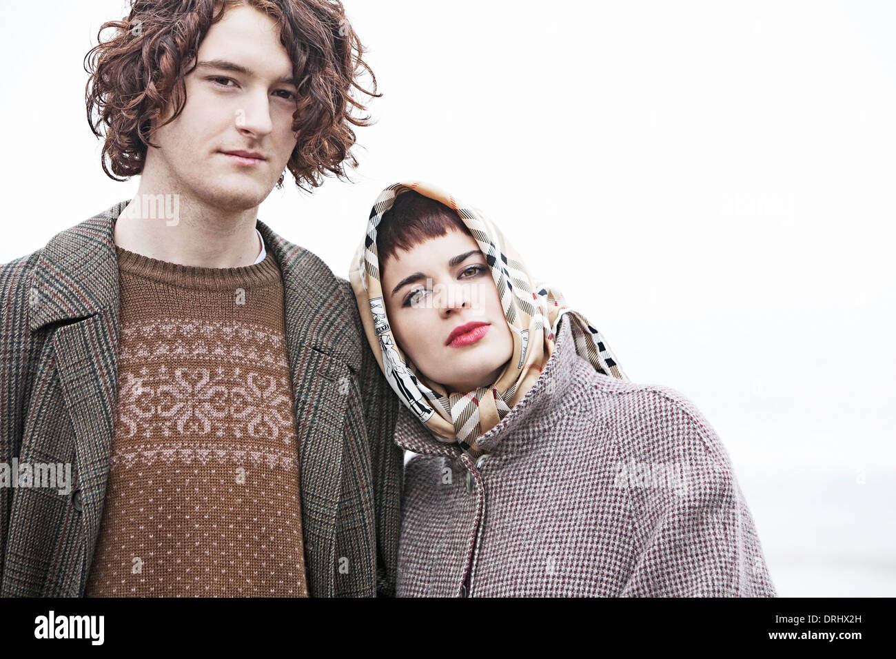 Couple by the sea wearing vintage fashion tweed couple Stock Photo - Alamy