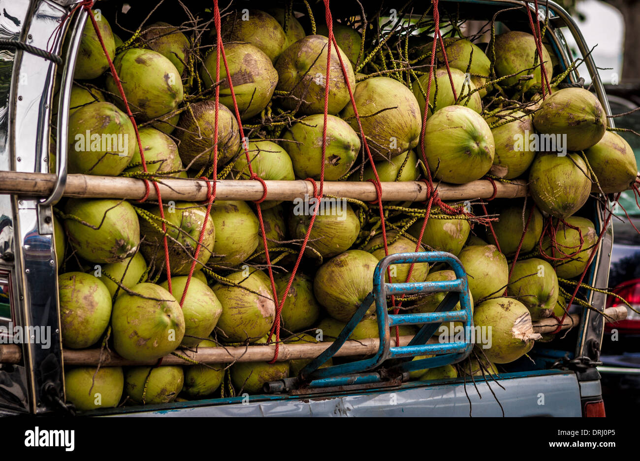 Coconuts loaded into back of pickup wagon Stock Photo - Alamy