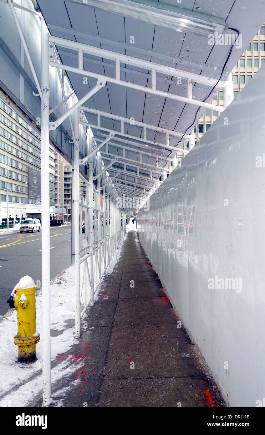 Pedestrian passage besides a building under construction in Toronto ...