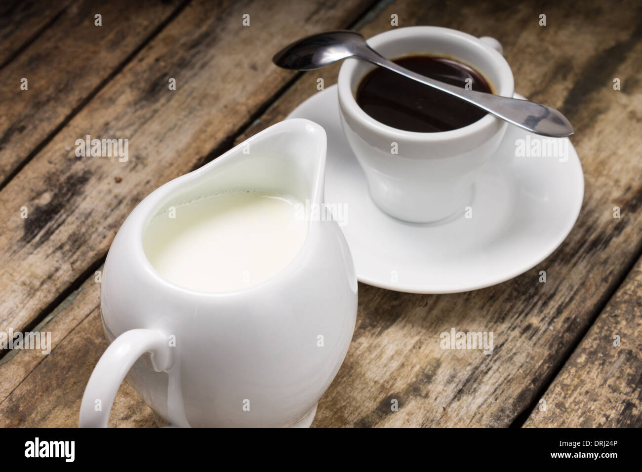Coffee. Cup of Coffee with Milk Jug on Wood Background Stock Photo - Alamy