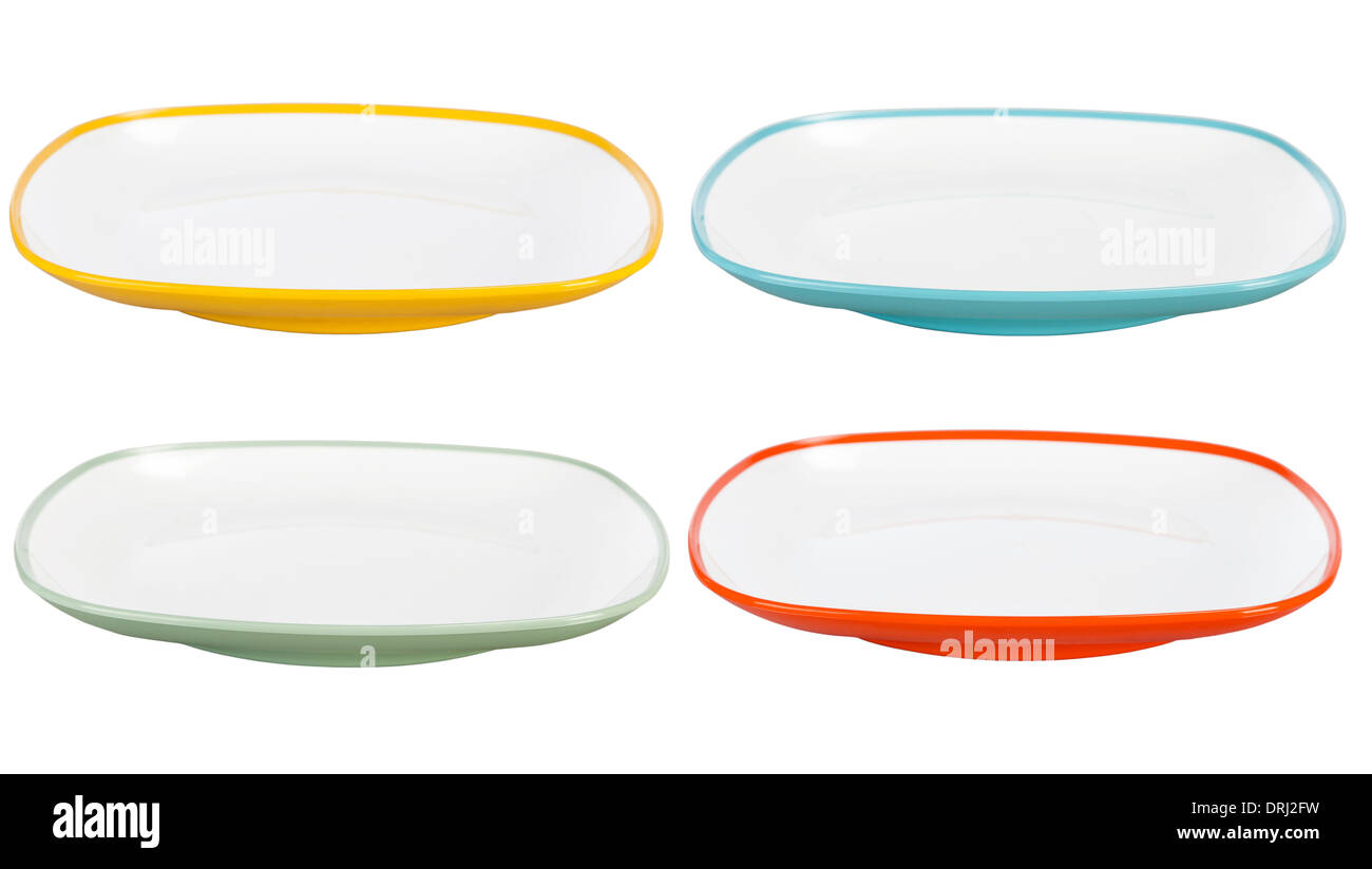 Green, blue, yellow, red plastic plates isolated on white background ...