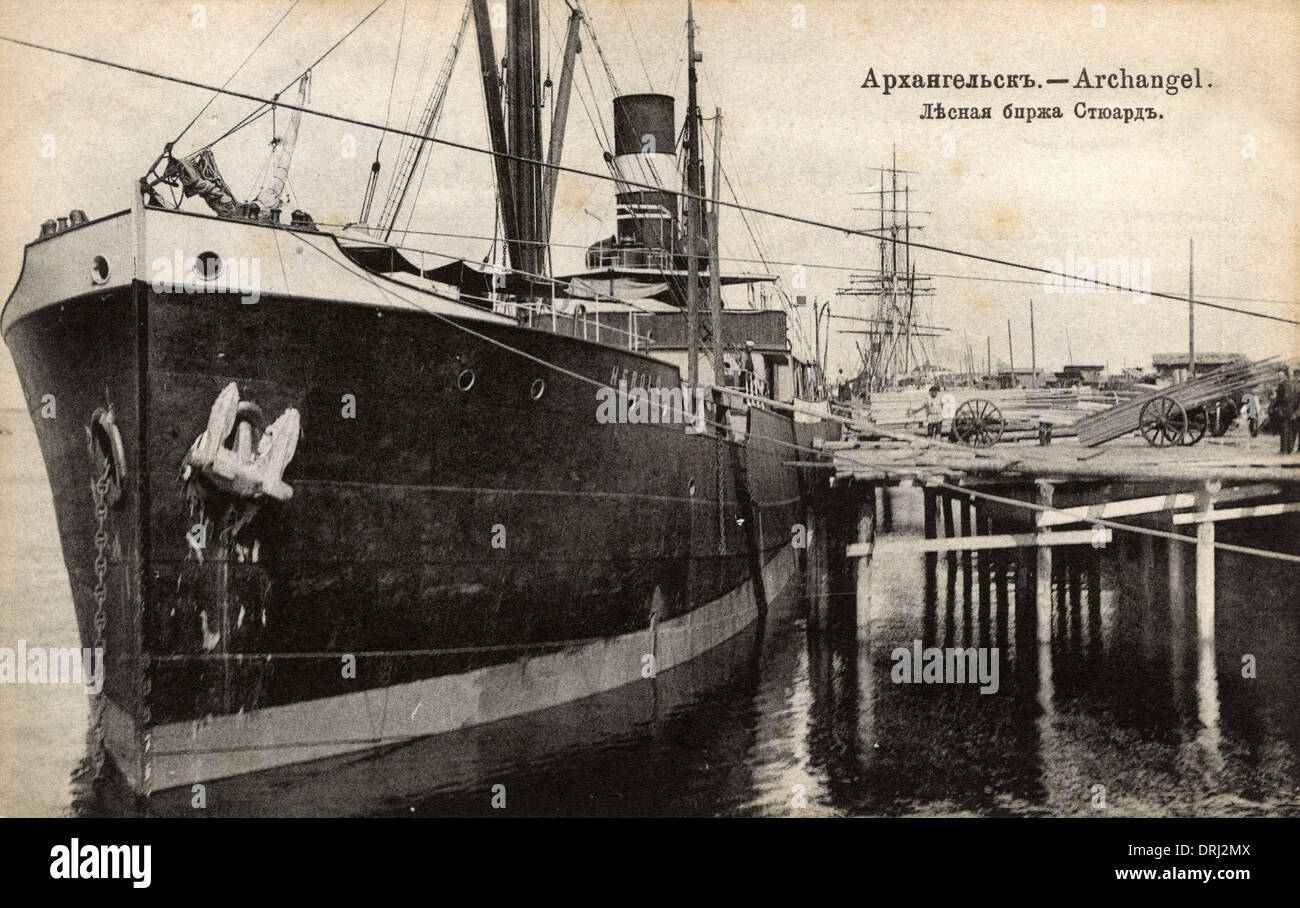 Loading wood onto ship at Archangel, Russia Stock Photo - Alamy