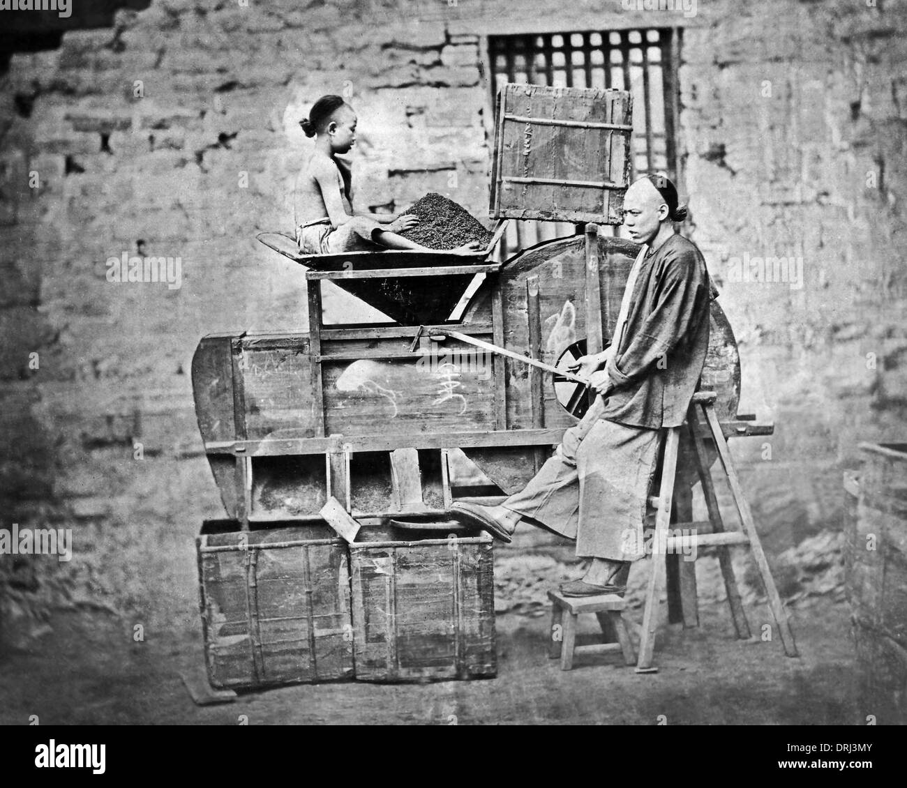 Man and boy sifting tea, China Stock Photo - Alamy