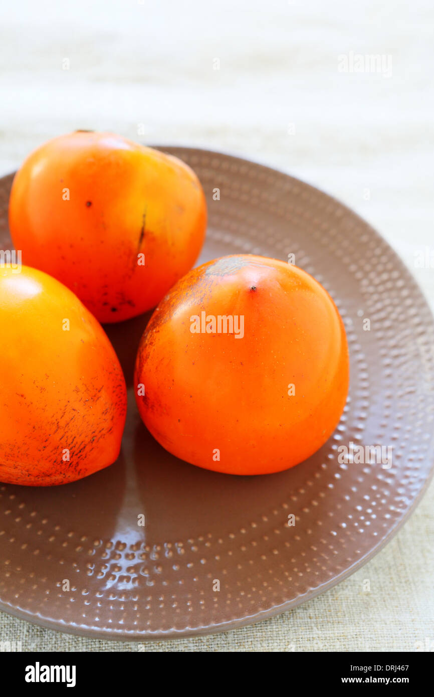 Plate sweet ripe persimmons hi-res stock photography and images - Alamy