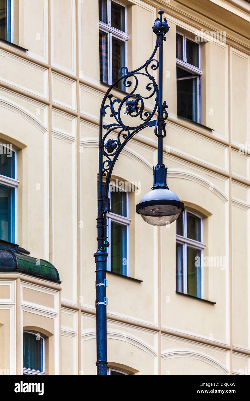 An ornate street light against the background of a historic house ...