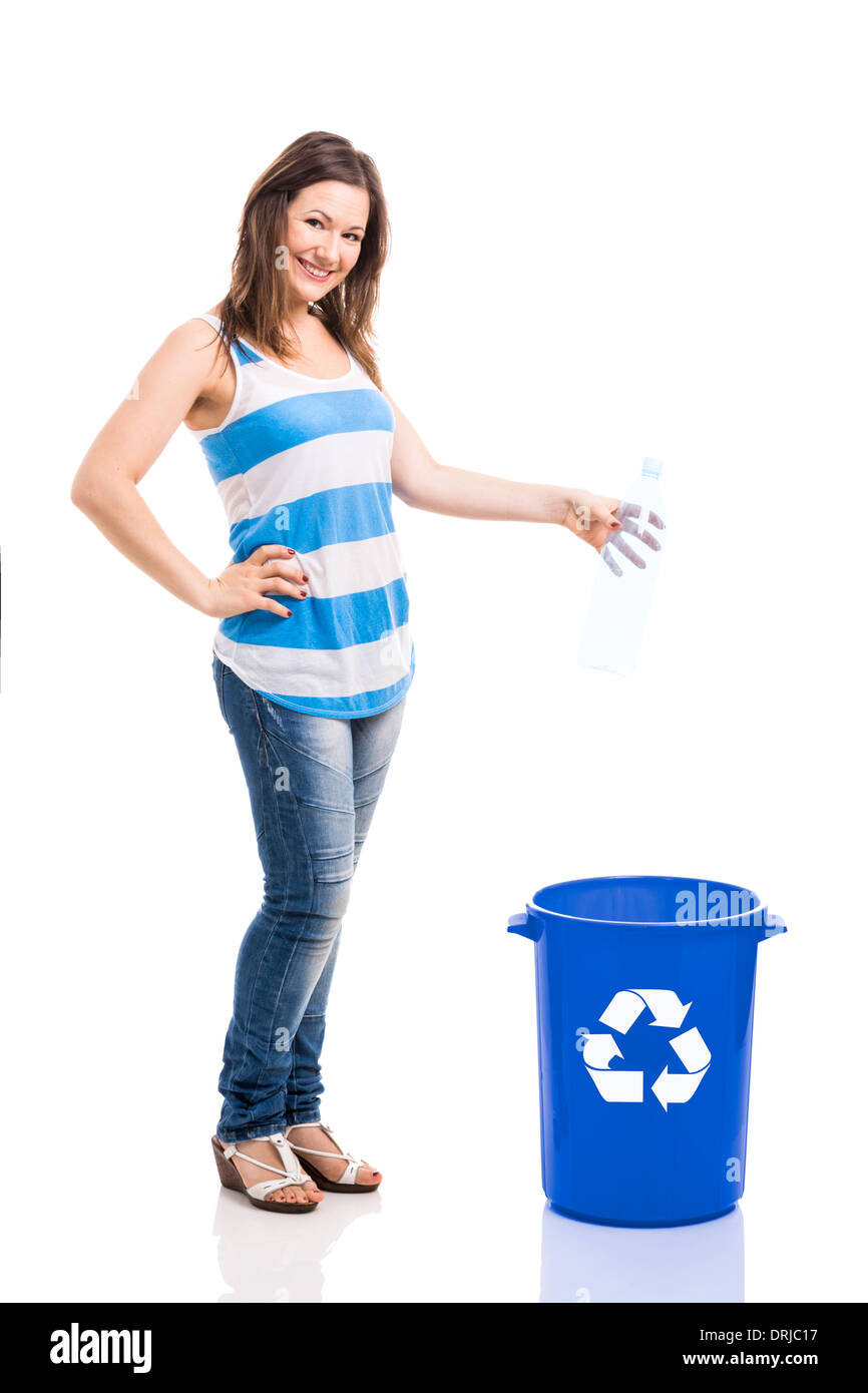Beautiful young woman doing recycling, isolated over white background ...