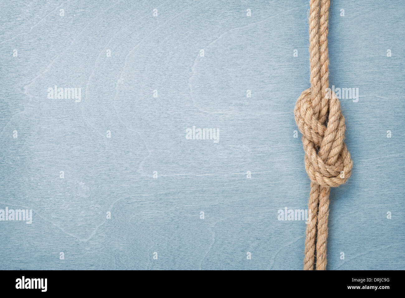 Ship rope knot on blue wooden texture background Stock Photo - Alamy