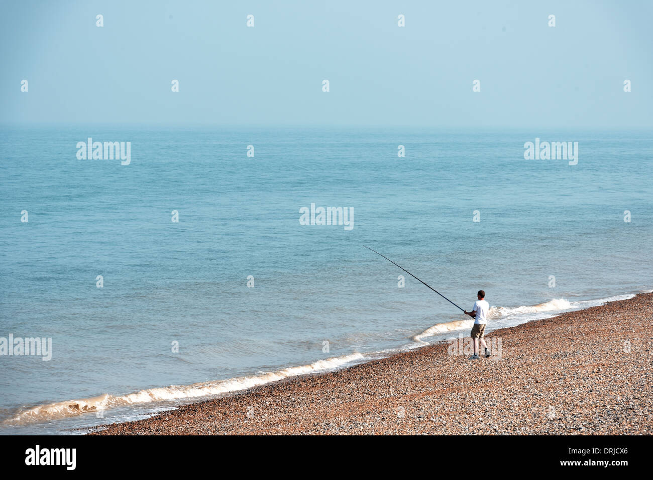Lone fisherman man fishing on the beach at Deal, Kent Stock Photo - Alamy