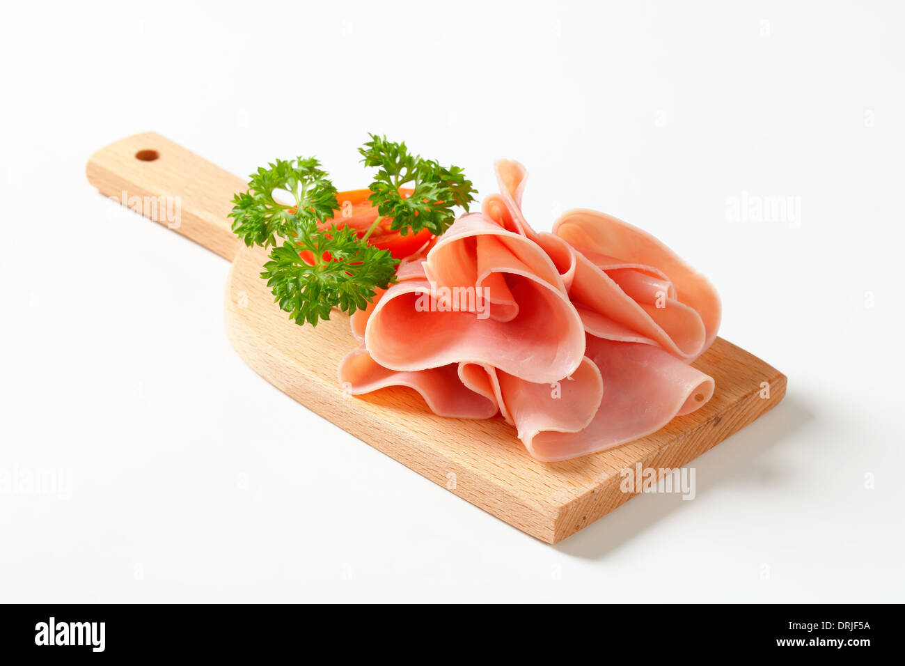 Thinly sliced ham on cutting board Stock Photo - Alamy
