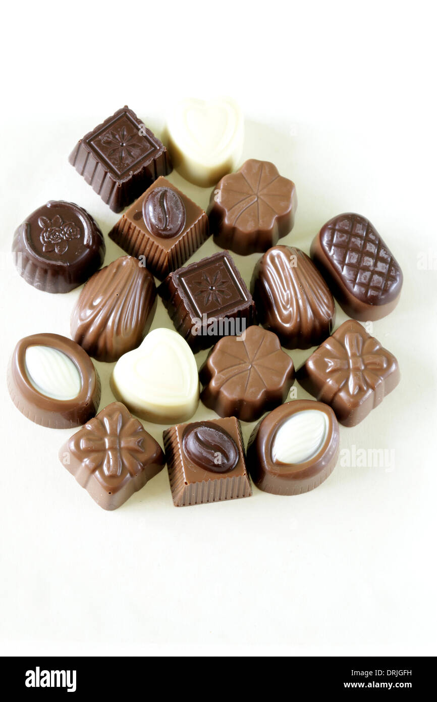 different varieties of chocolate and sweets on a white background Stock ...