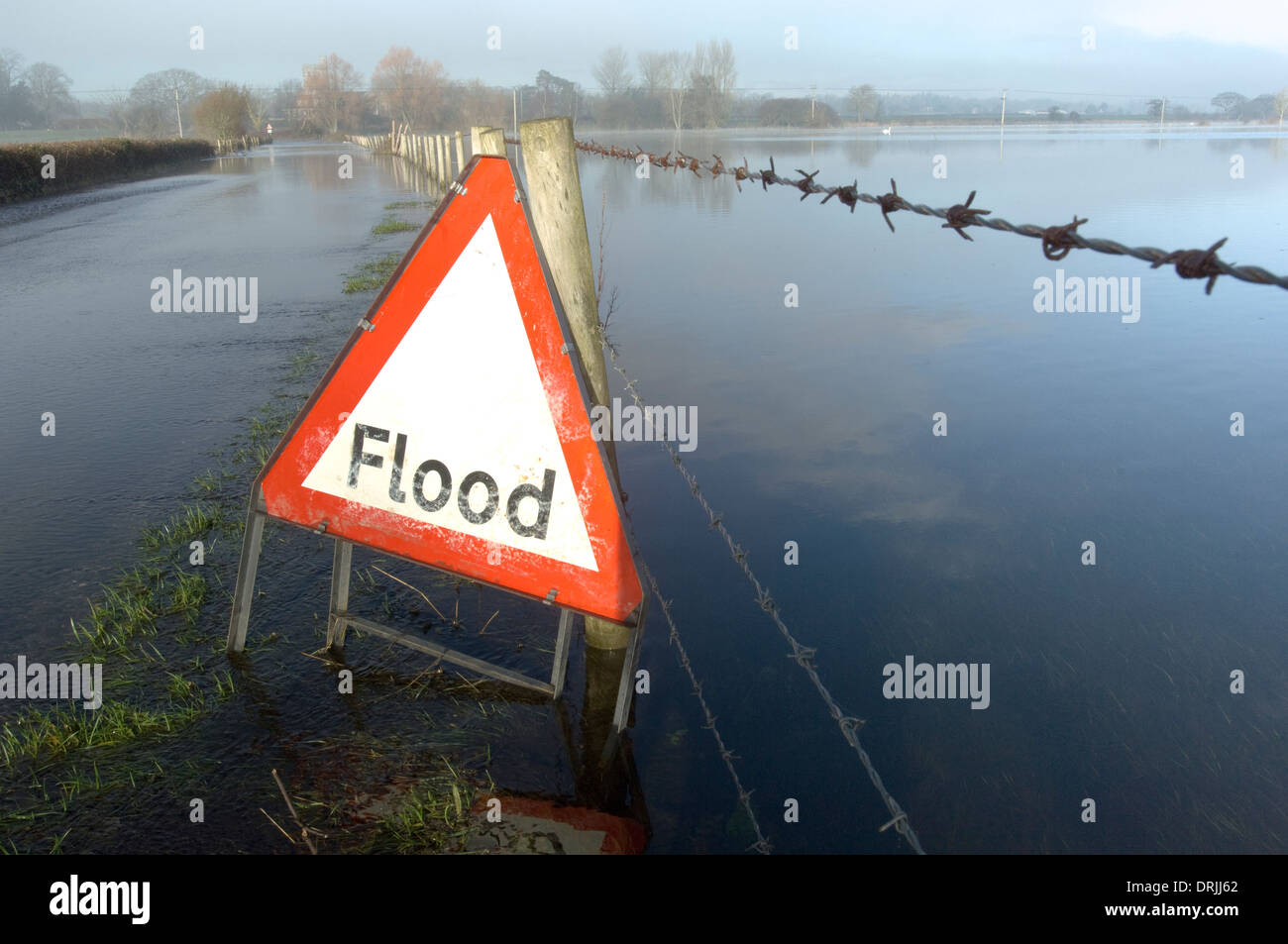 Flooded country road with warning sign Stock Photo - Alamy