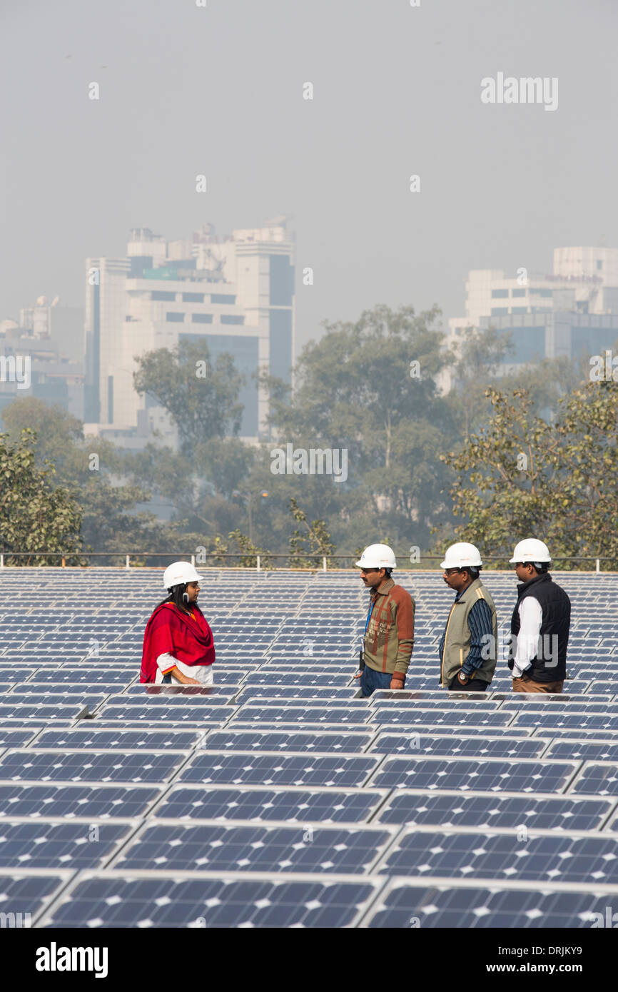 Workers at a 1 MW solar power station run by Tata power on the roof of ...