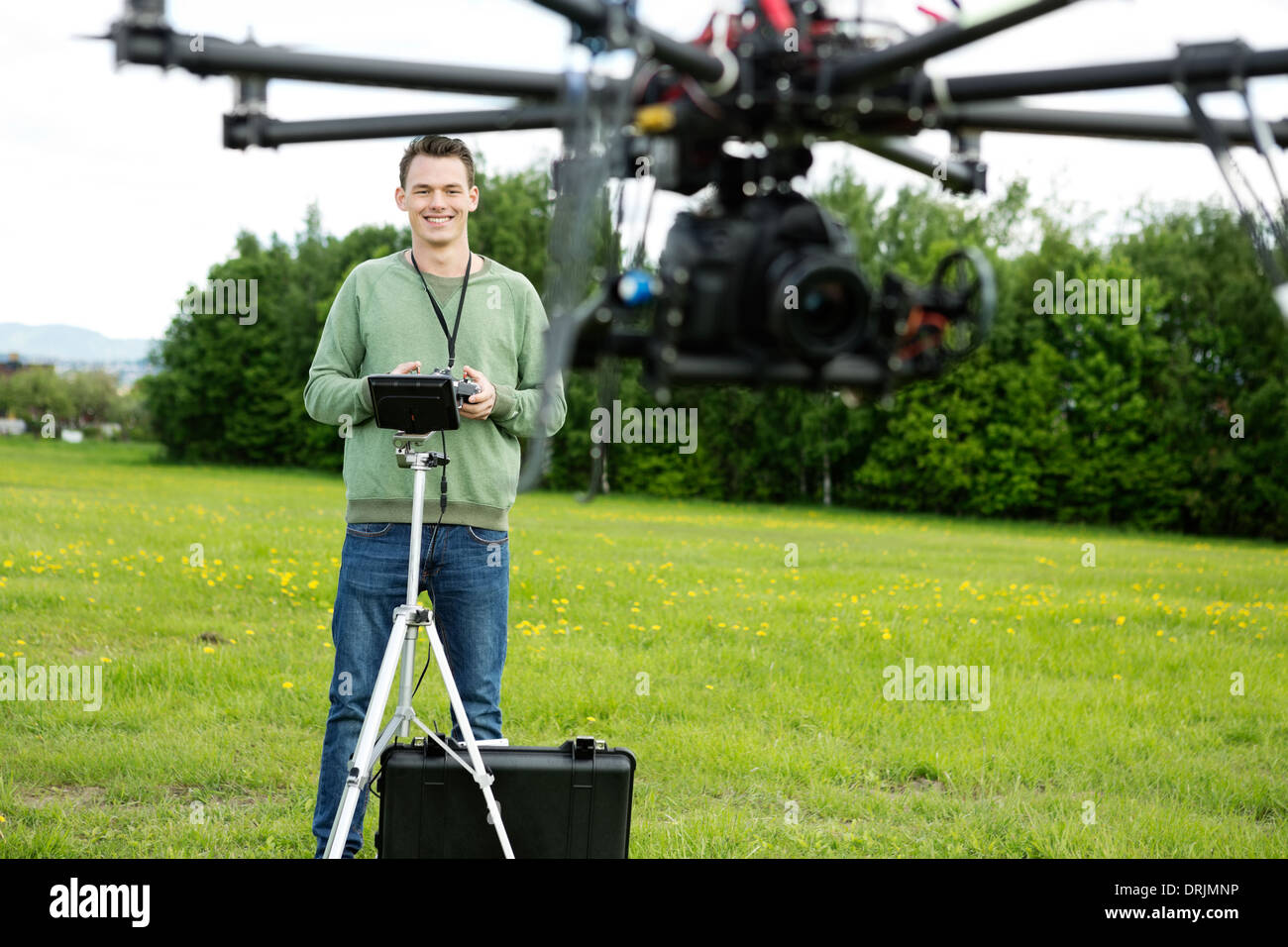 Happy Engineer Operating UAV in Park Stock Photo - Alamy