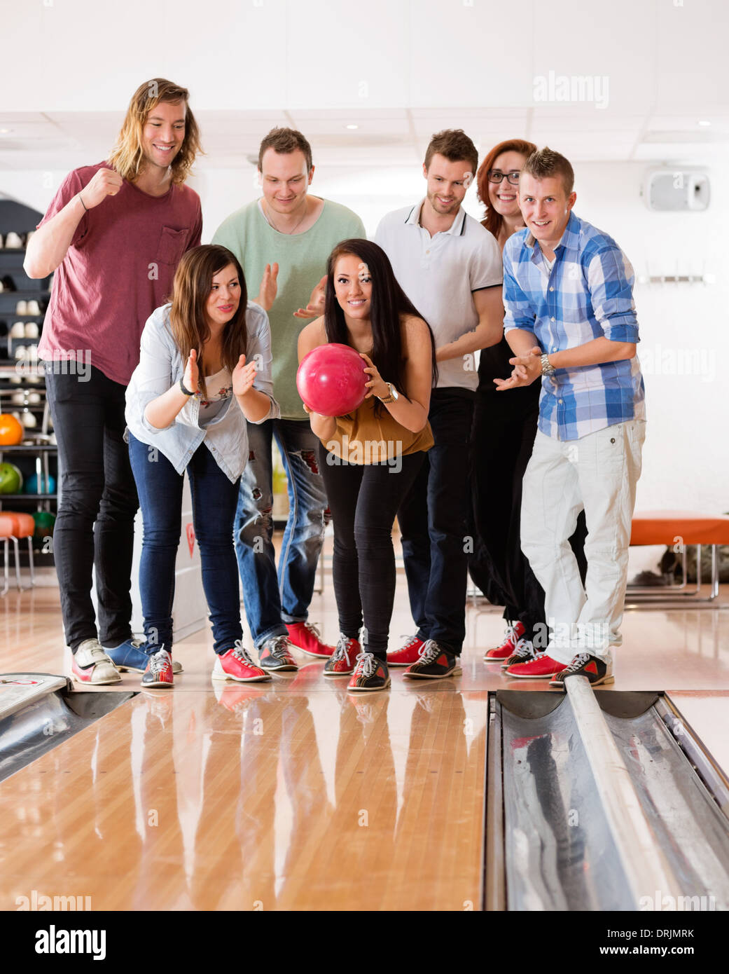 Woman Bowling While Friends Cheering Stock Photo - Alamy