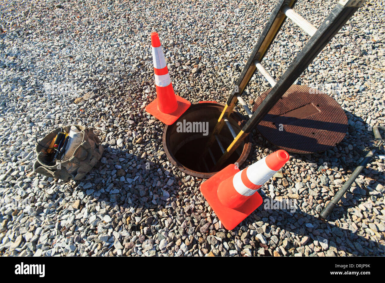 Ladder in manhole and warning cones at high voltage power distribution ...