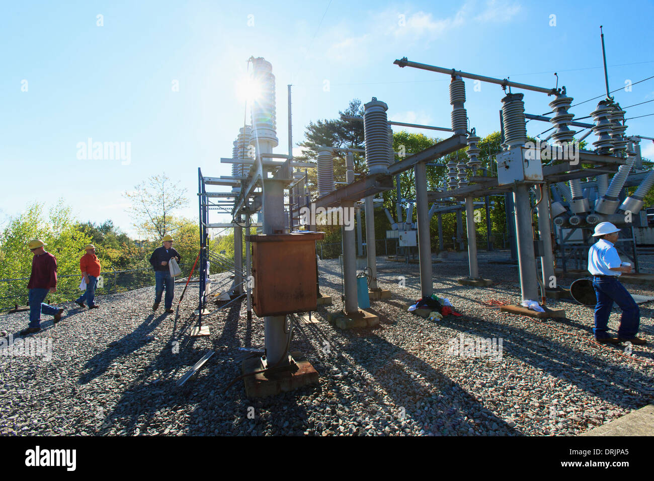 Power engineers preparing to work on high voltage power distribution ...