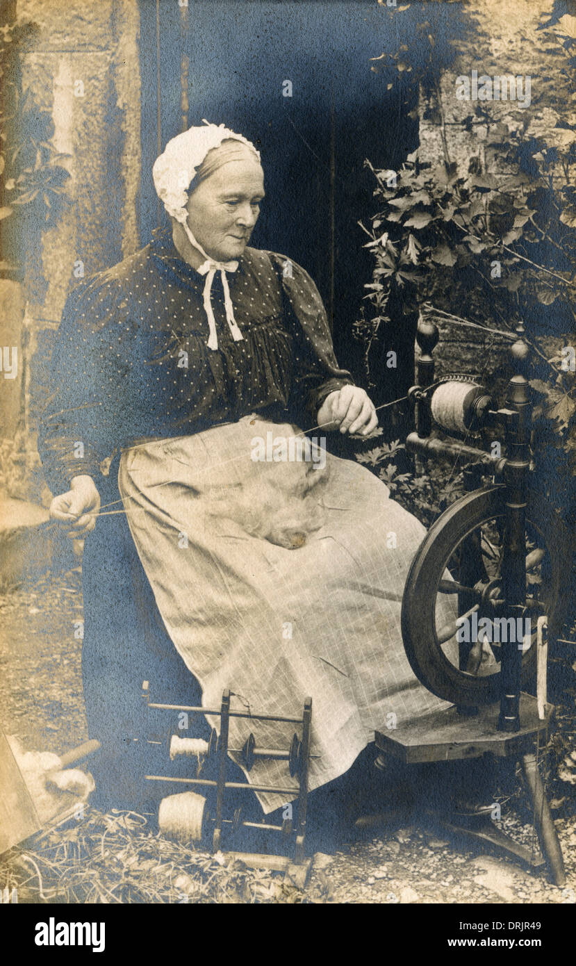 Old woman with spinning wheel hi-res stock photography and images - Alamy