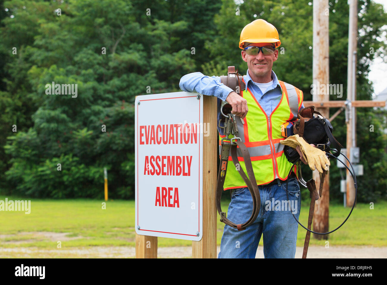 Communications engineer with climbing equipment and tool belts at ...