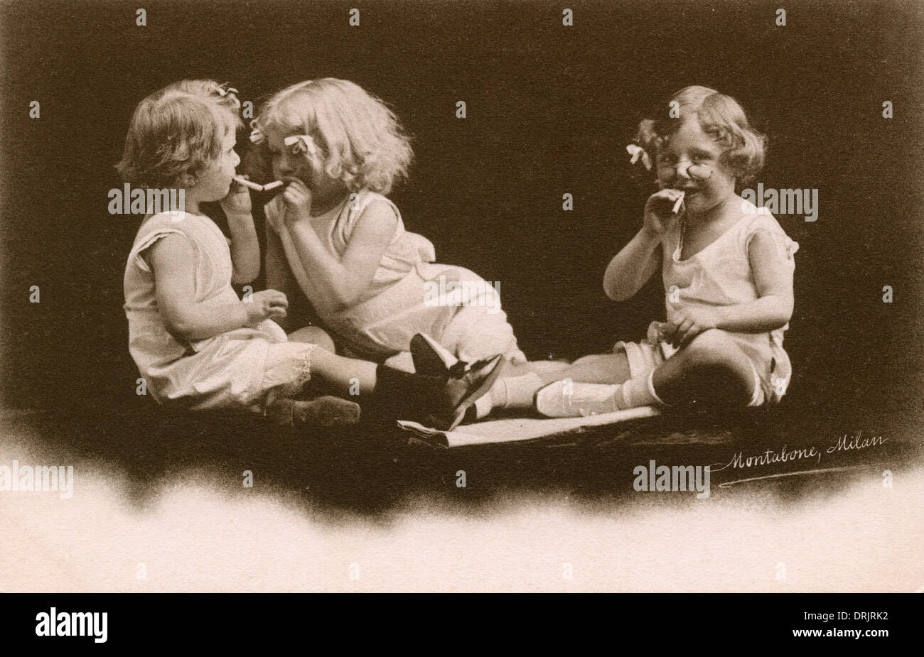 Three little girls playing grown-ups, smoking Stock Photo - Alamy