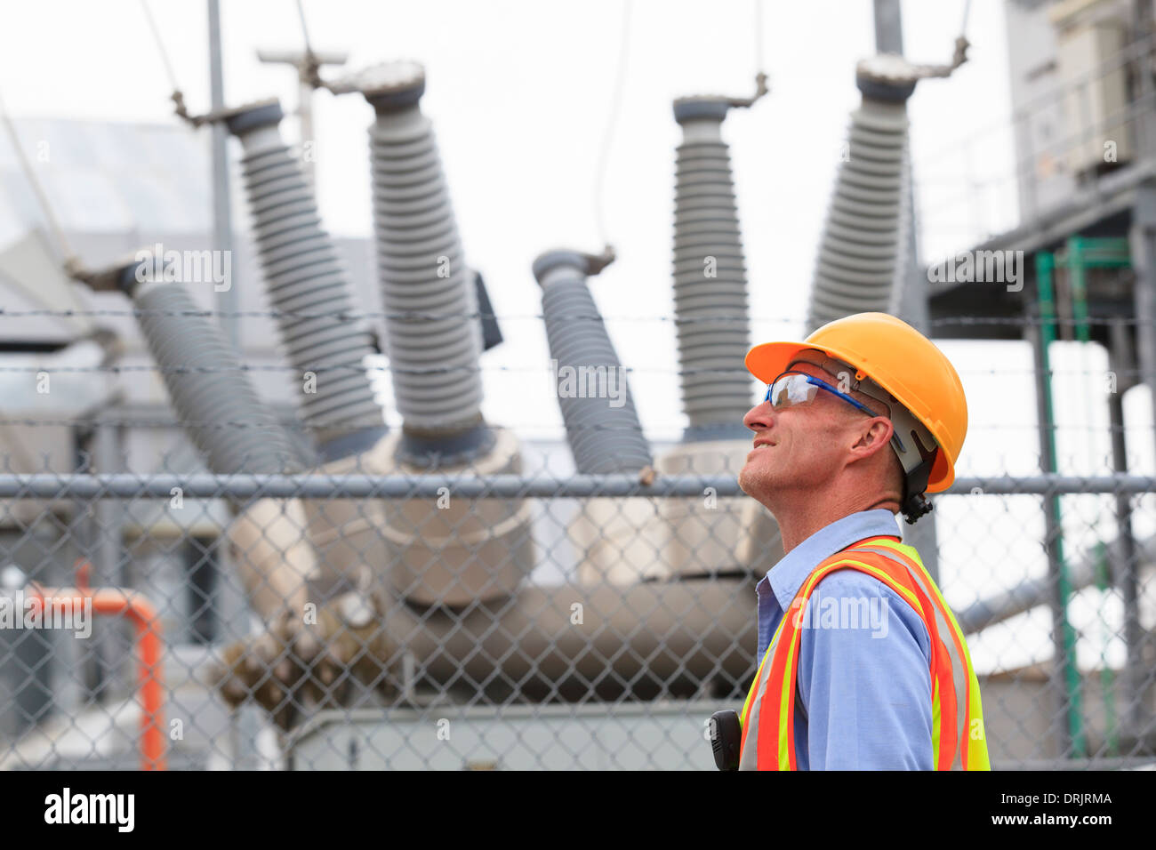 Electrical engineer examining transformers inside of an electric power ...