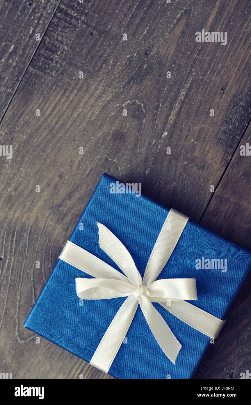 Blue elegant gift box on a wooden background Stock Photo - Alamy