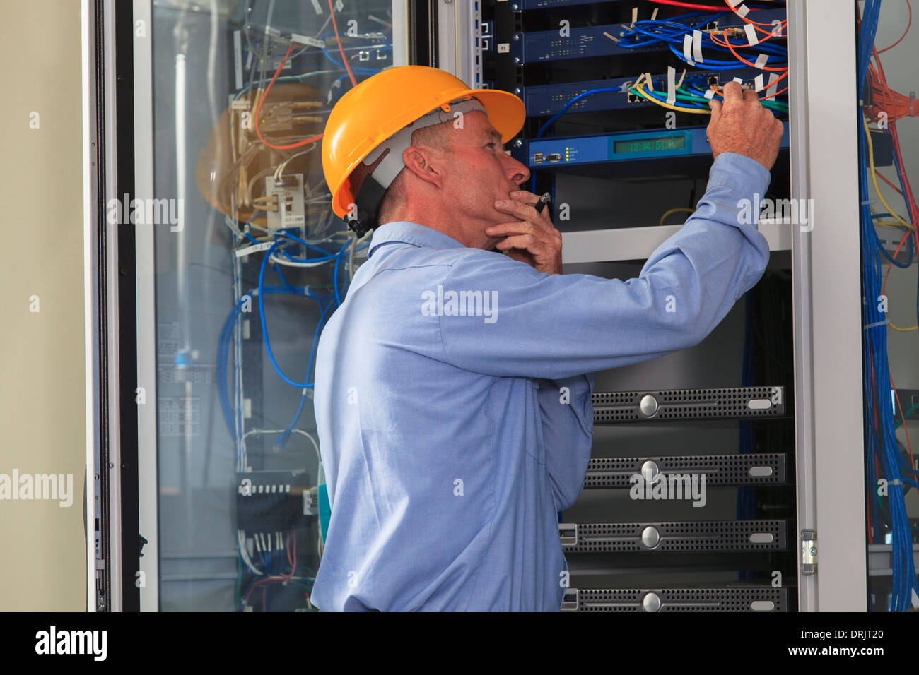 Electrical engineer working with switches and servers in broadband ...