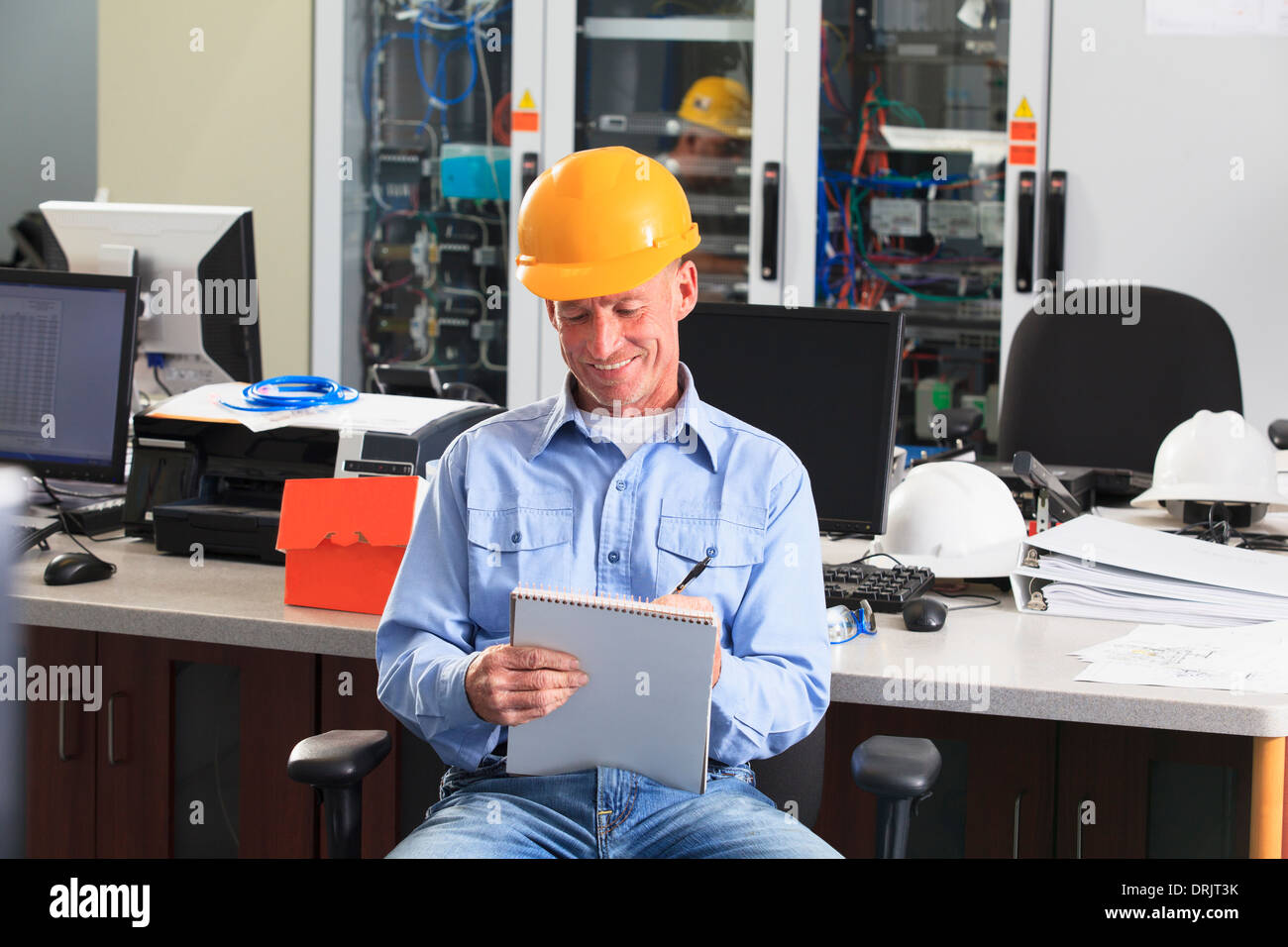 Electrical engineer working in central operations room of power plant ...