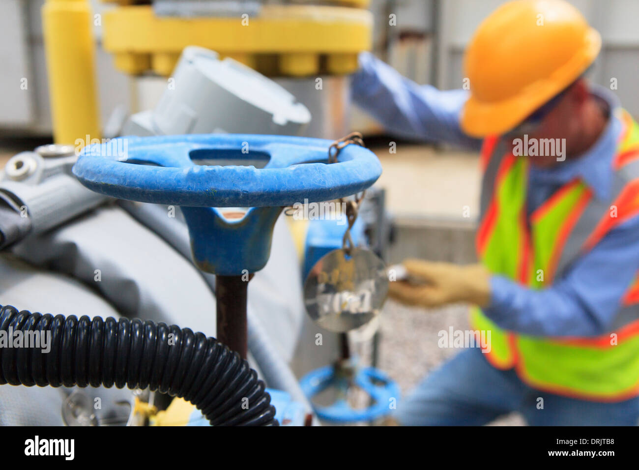 Engineer at electric power plant working with manual valves Stock Photo ...