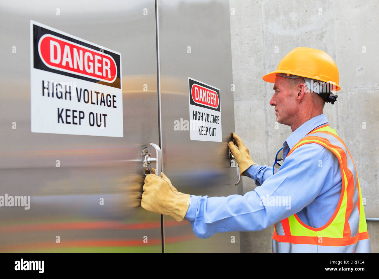 Engineer at electric power plant opening high voltage area doors Stock ...