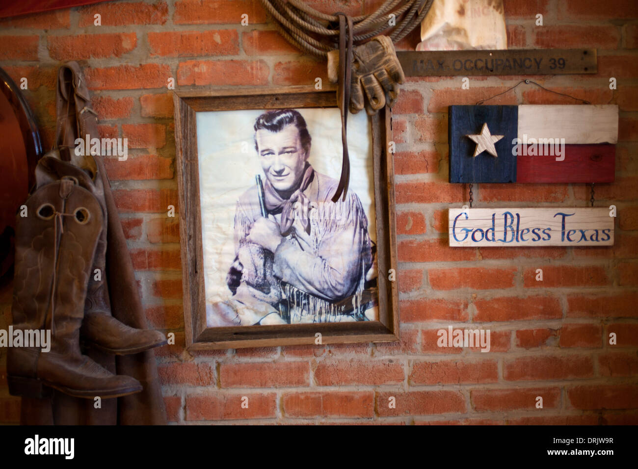 A picture of John Wayne and a Texan flag decorate a shop in South ...