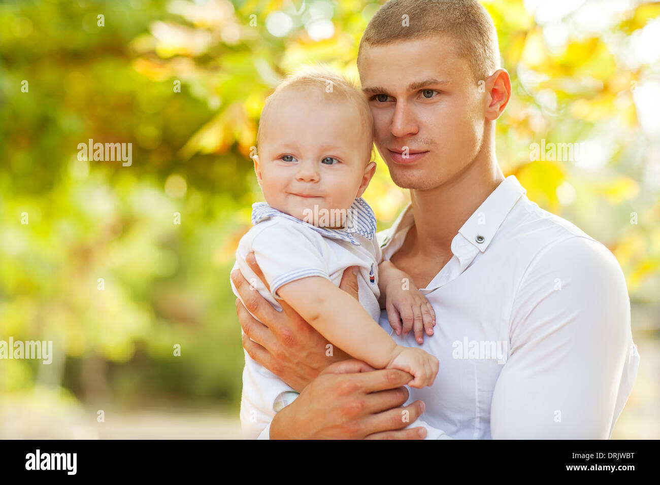 Happy young man holding a smiling 7-9 months old baby Stock Photo - Alamy