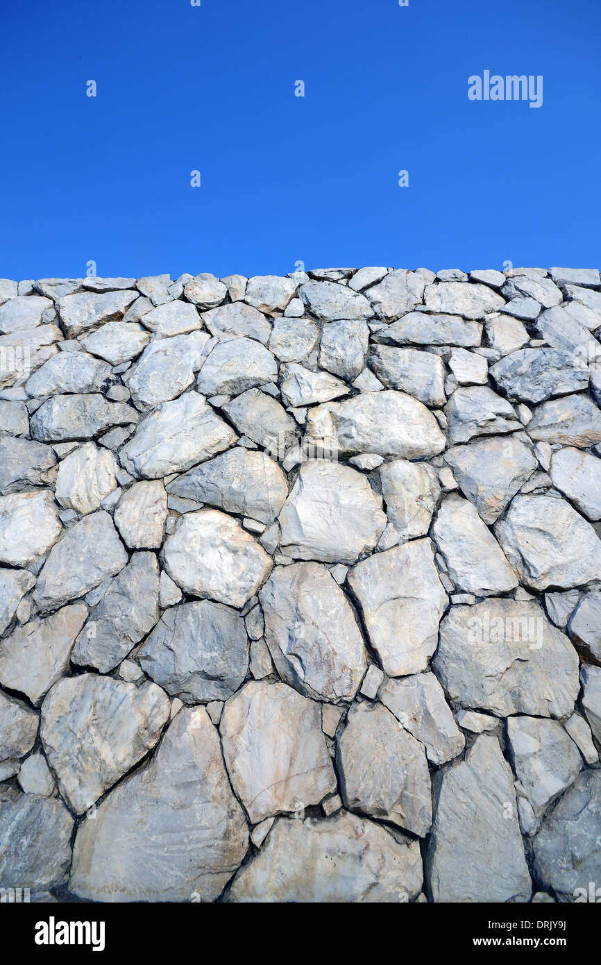 Stone wall background and texture with blue sky Stock Photo - Alamy