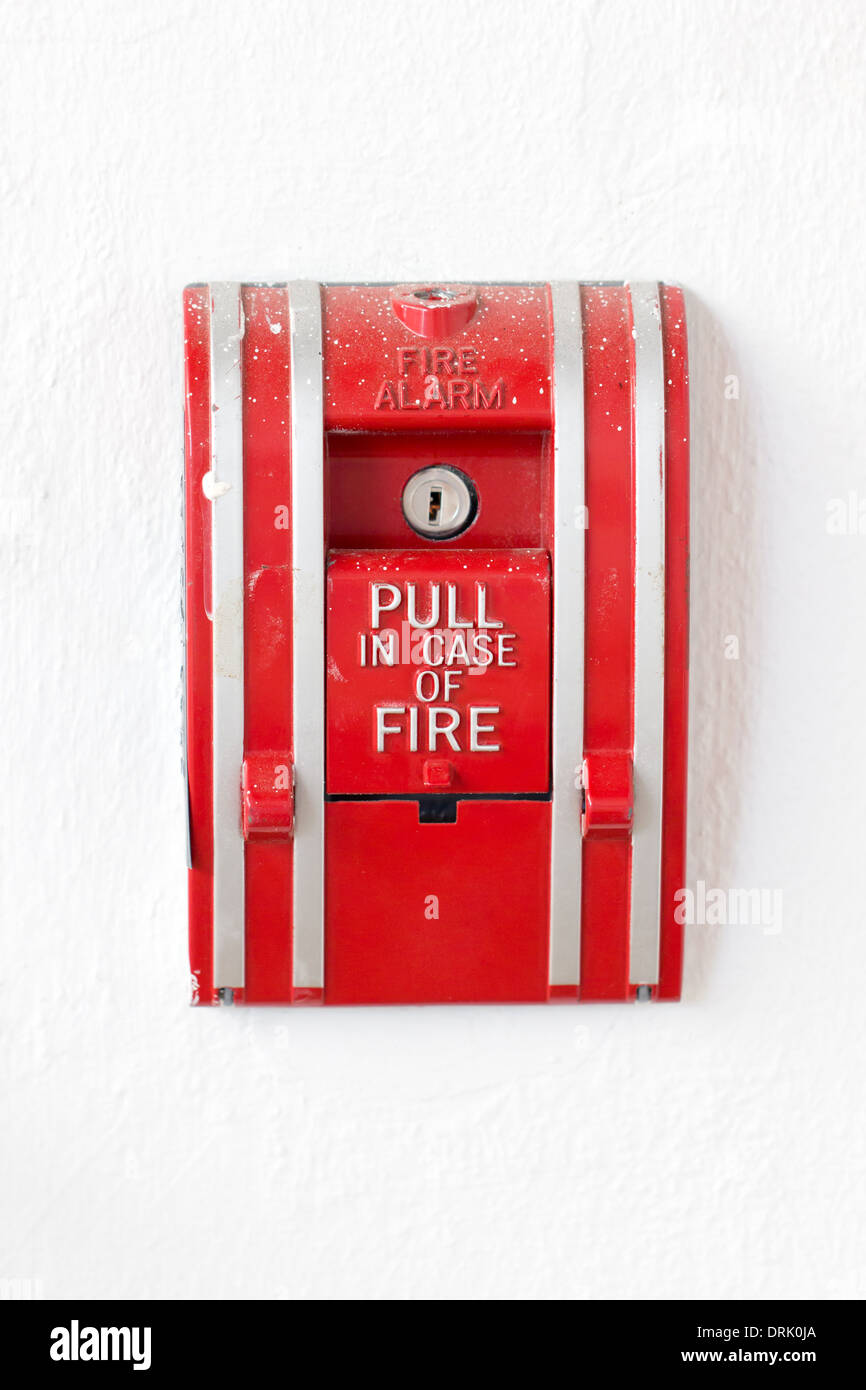 Red fire alarm pull switch isolated on white Stock Photo - Alamy