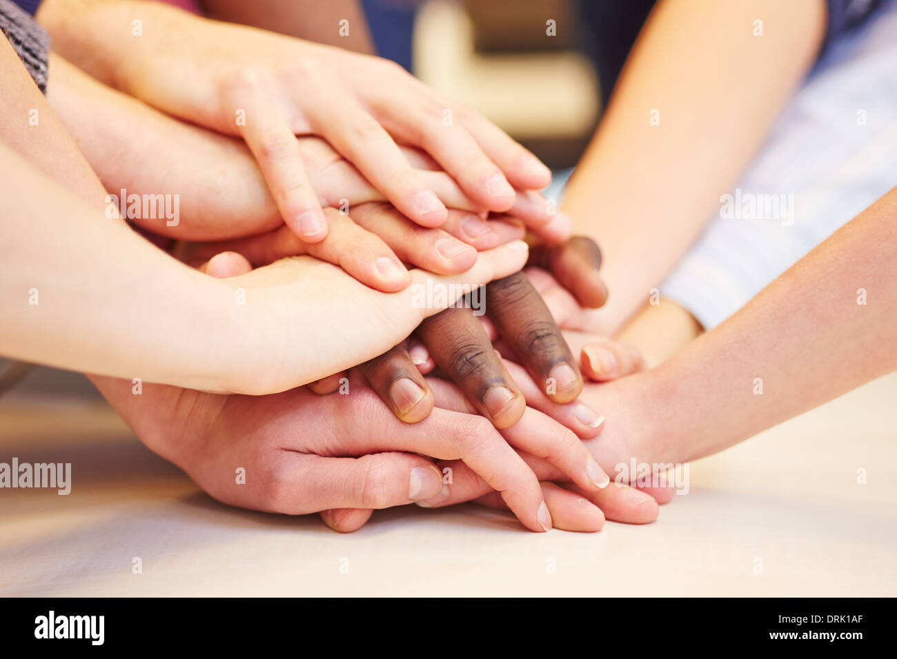 Motivation and teamwork with many hands stacked in school Stock Photo ...
