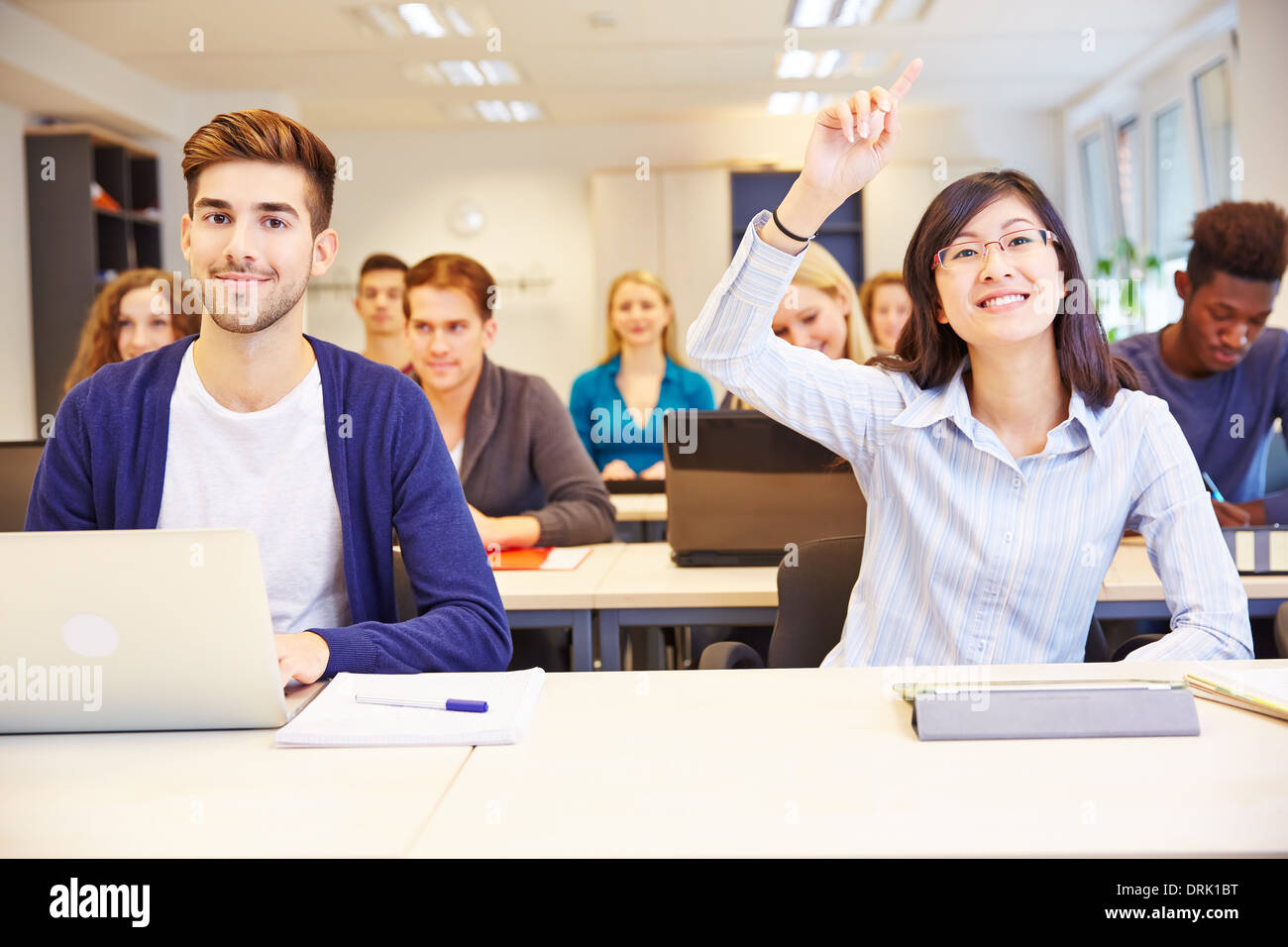 Asian student raising her hand in a university classroom Stock Photo ...