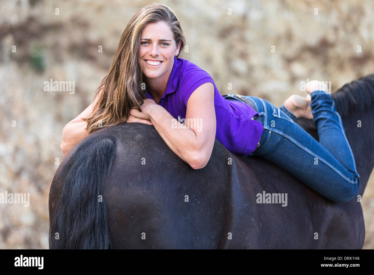 Kaimanawa Horse. Vicky Wilson lying on a chestnut gelding. New Zealand ...