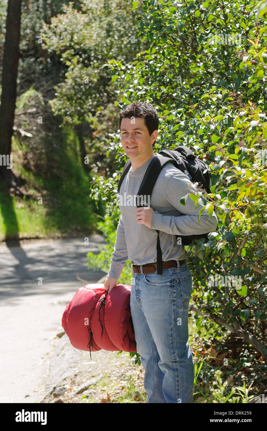 young man going hiking, camping, being outdoor in nature. He has a ...