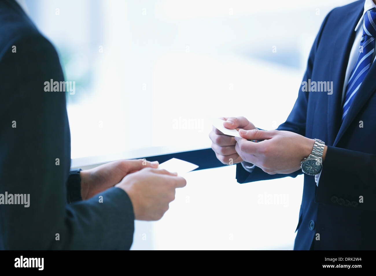 Two businessmen exchanging business card hi-res stock photography and ...