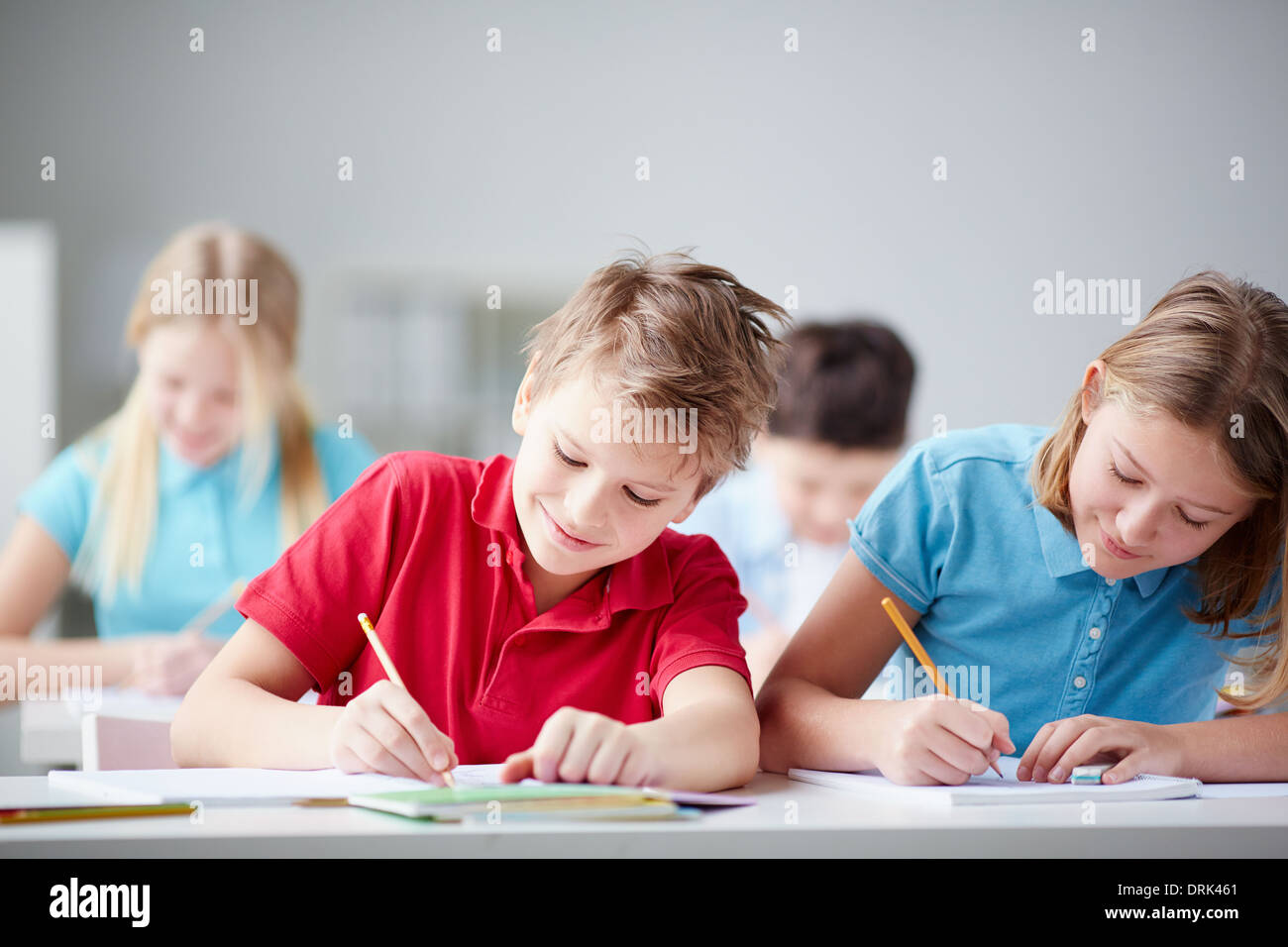 Portrait of two diligent pupils drawing at lesson Stock Photo - Alamy