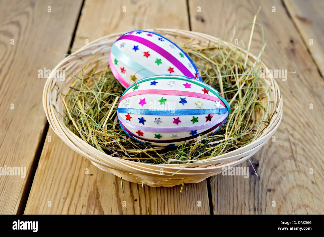 Two easter eggs, decorated with multicolored braid and sparkles in the ...