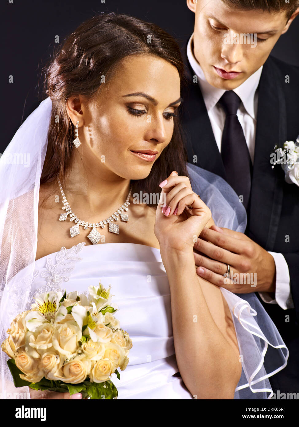 Bride and groom wearing wedding dress and costume Stock Photo - Alamy