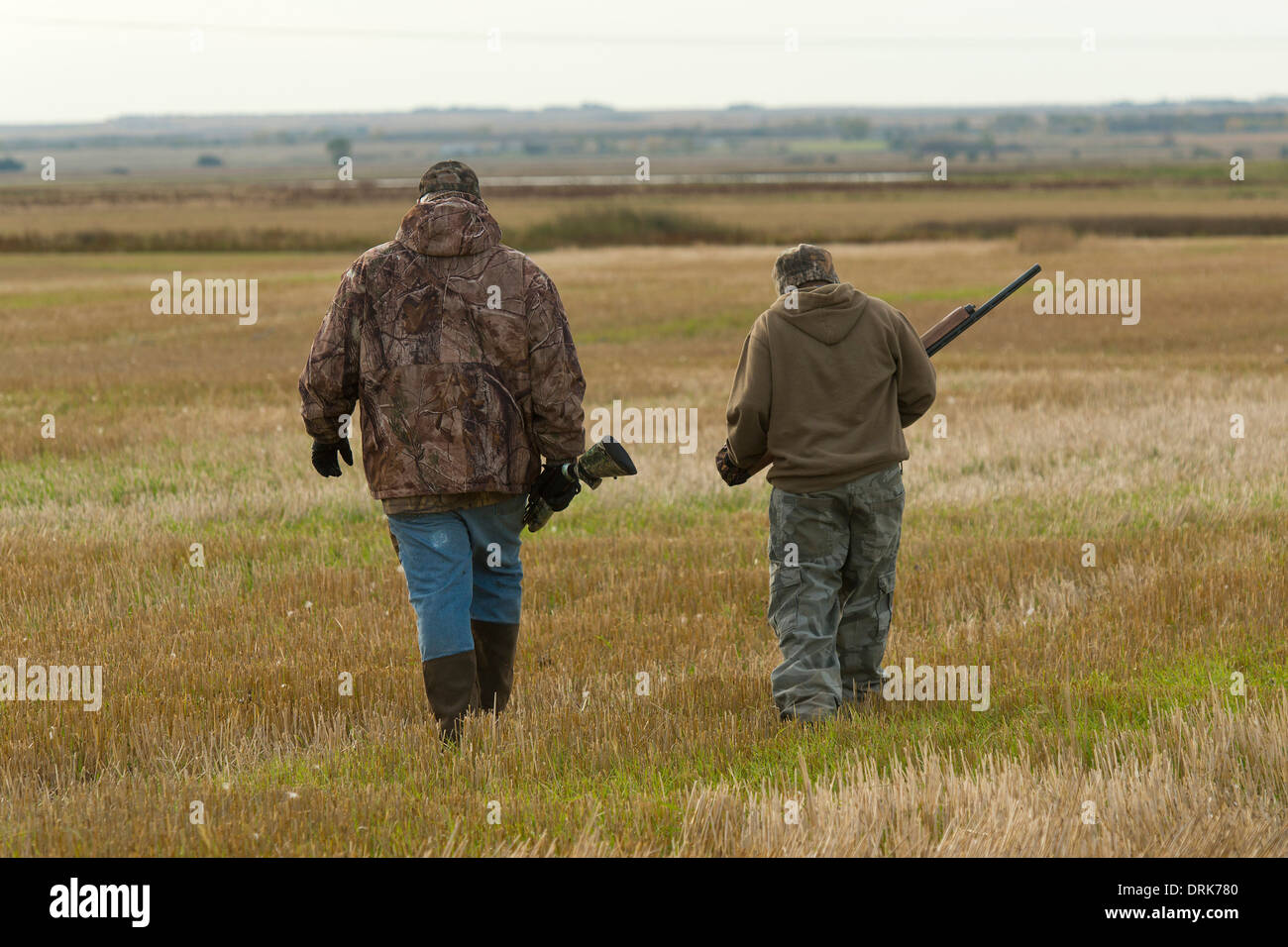 Hunters in field Stock Photo - Alamy
