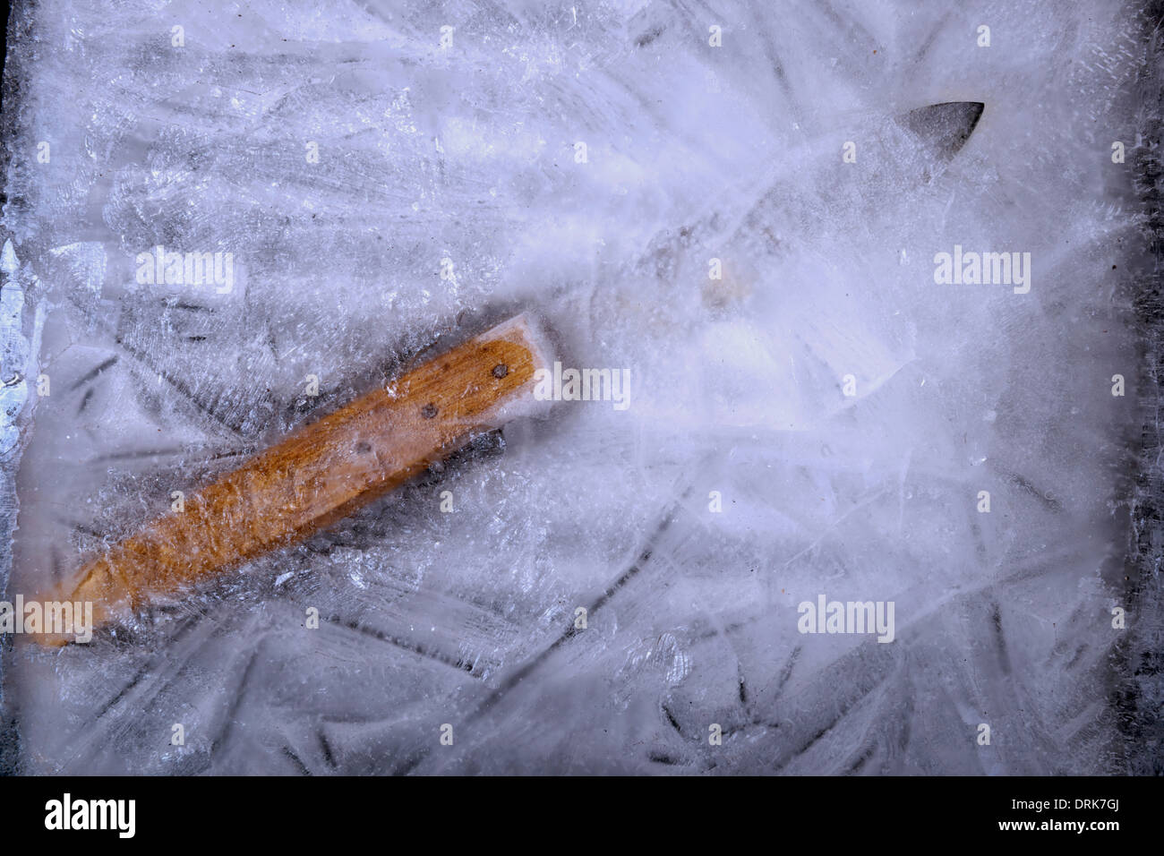 Frozen knife in ice block Stock Photo - Alamy