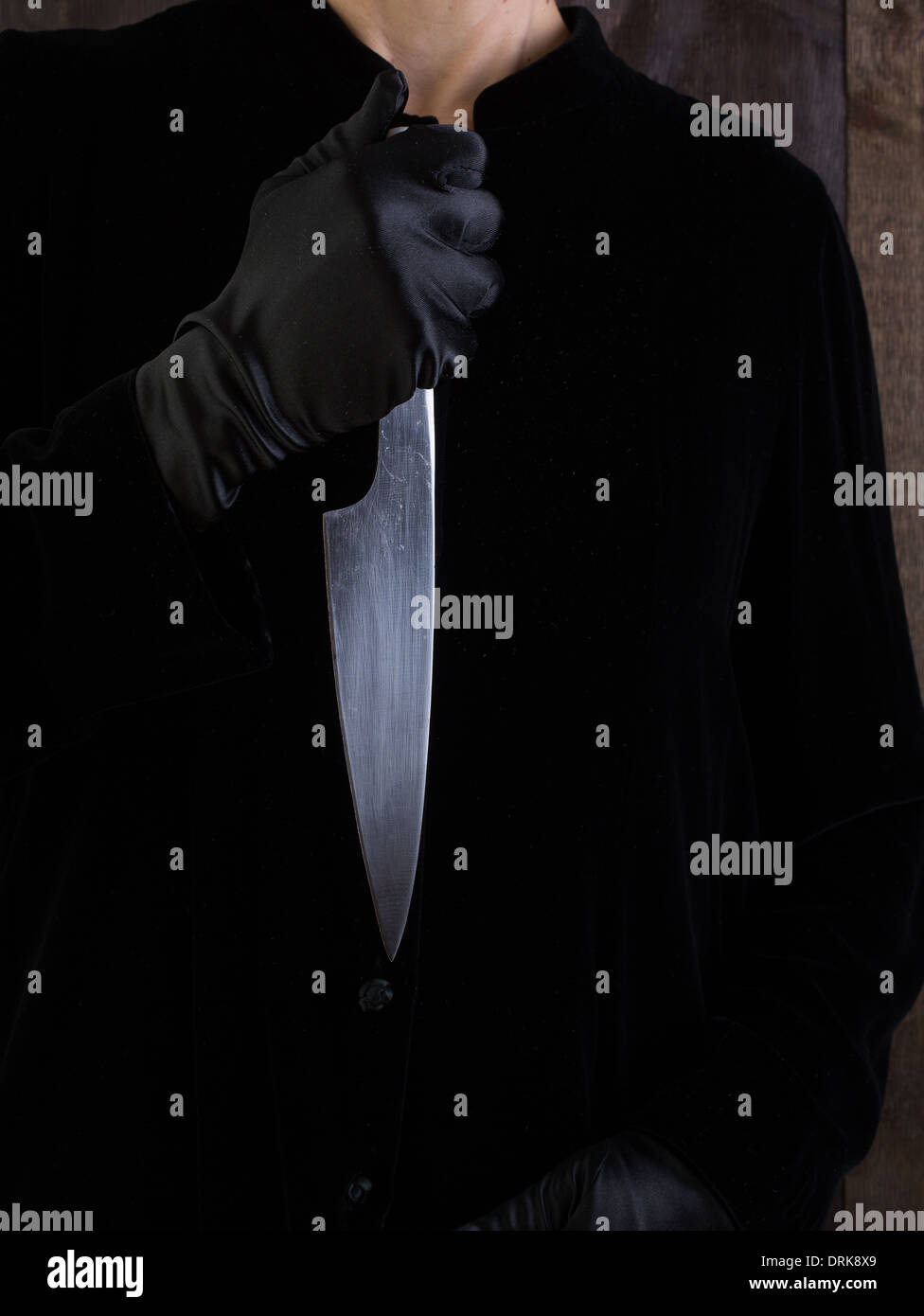 A cropped image of a woman welding a large menacing large silver ...