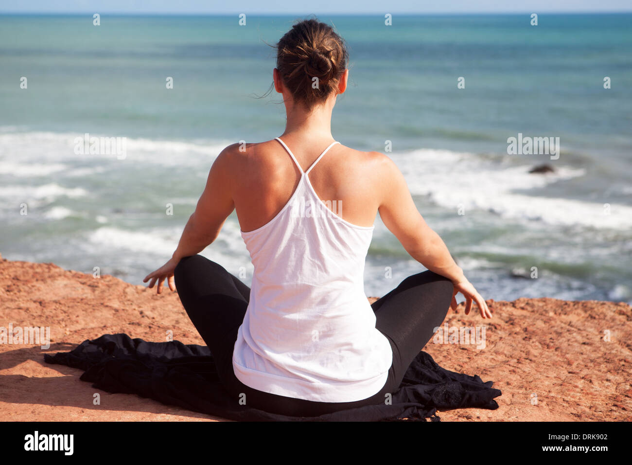 Yoga exercise on sea coast Stock Photo - Alamy