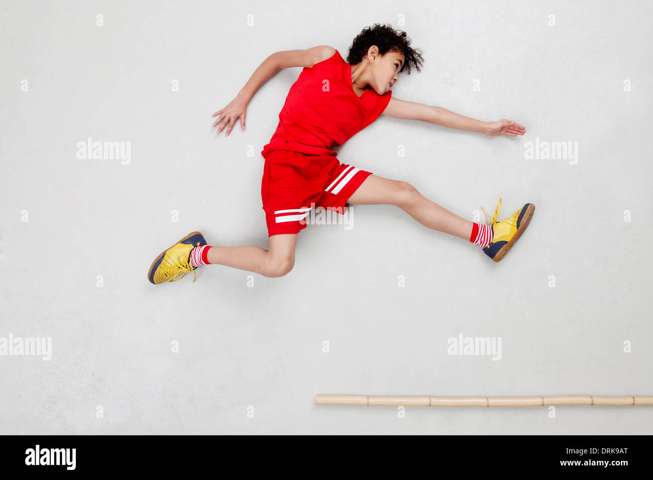 Boy doing long jump Stock Photo - Alamy