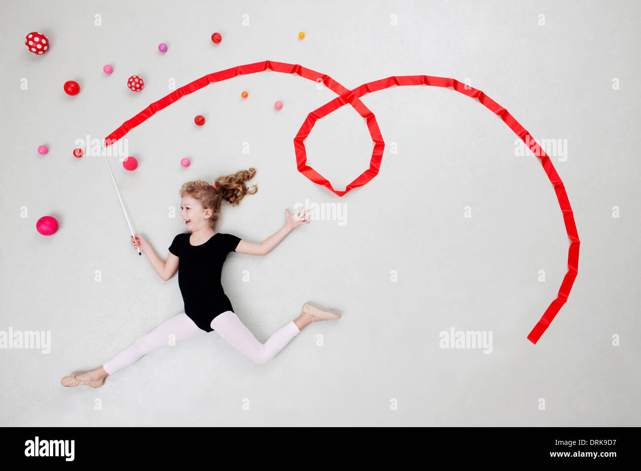 Girl doing rhythmic gymnastics with balls and ribbon Stock Photo - Alamy