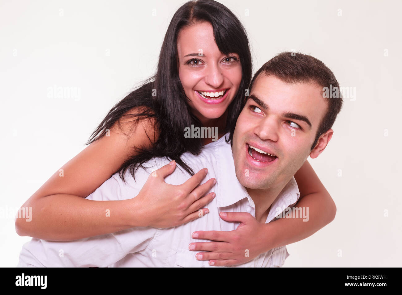 Playful young couple giving a piggy back ride Stock Photo - Alamy